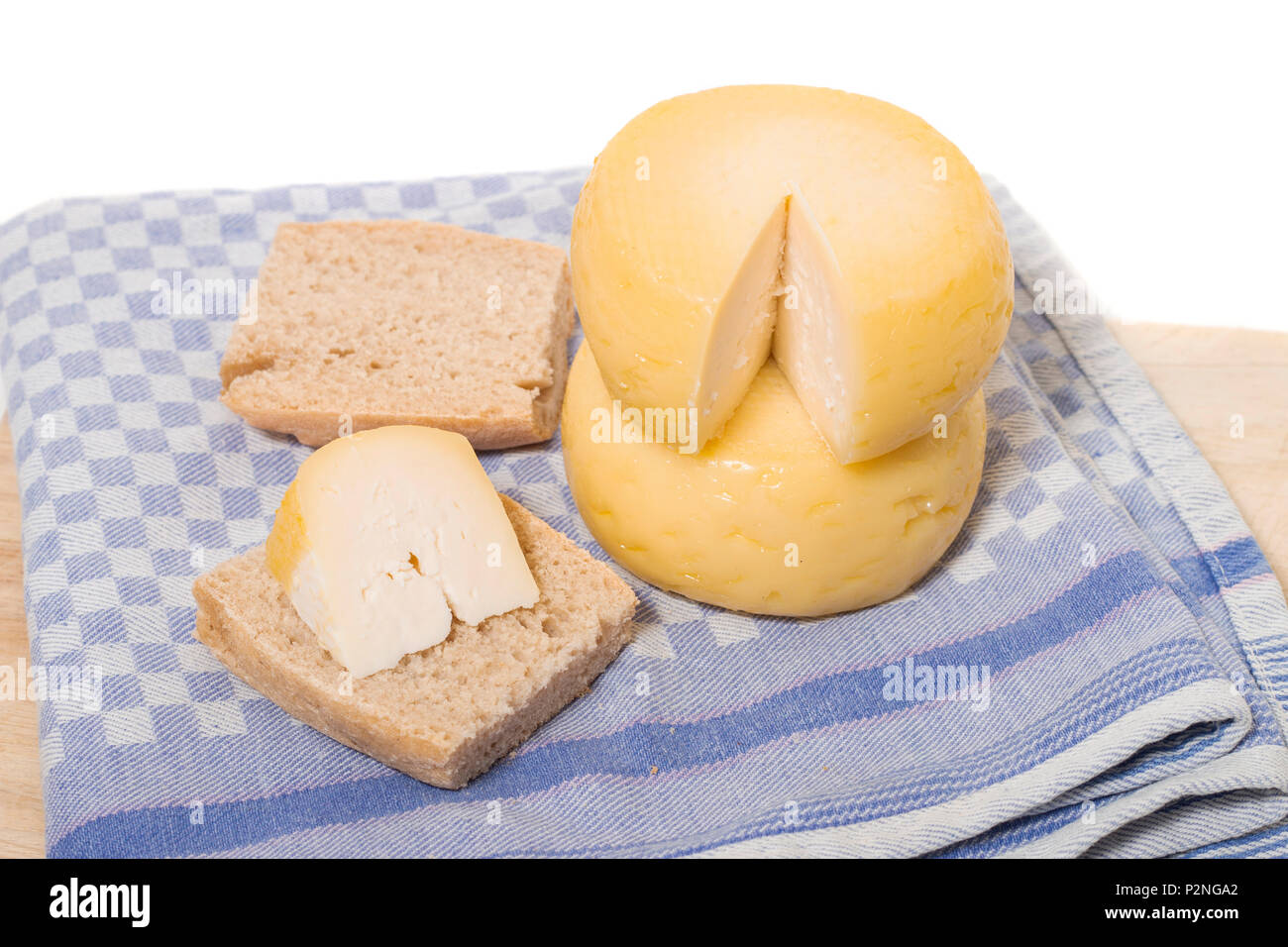 Yellow goat cheese isolated on a white background Stock Photo - Alamy