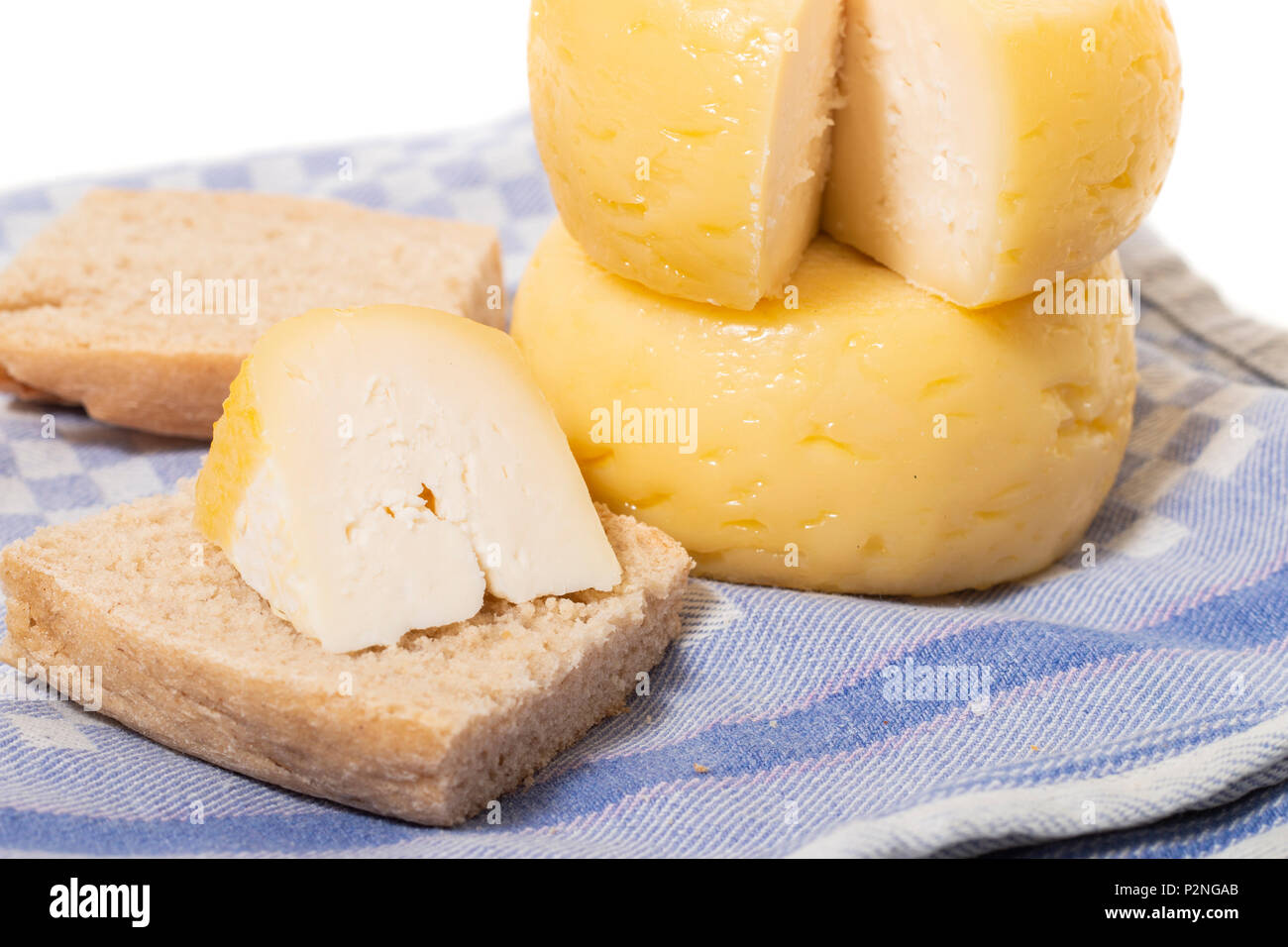 Yellow goat cheese isolated on a white background Stock Photo - Alamy