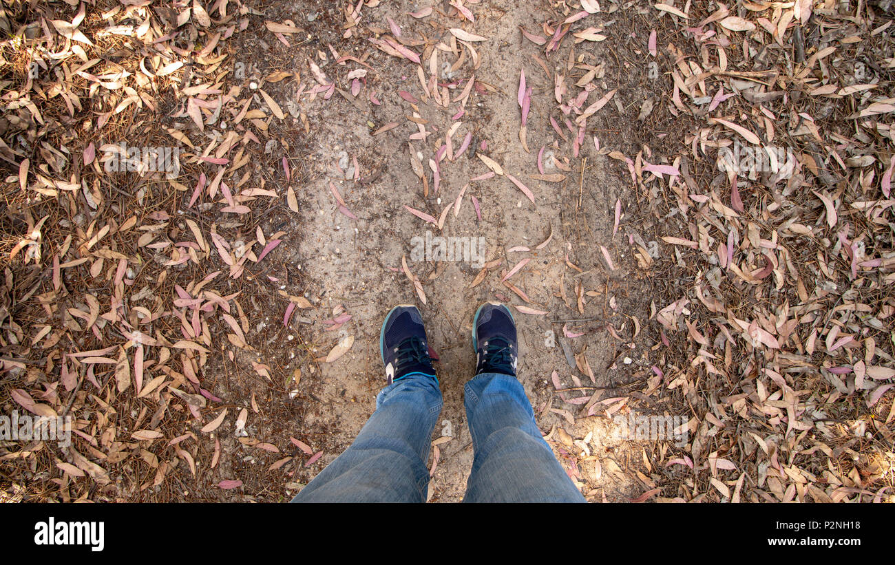 Top view of legs on dirt path Stock Photo - Alamy
