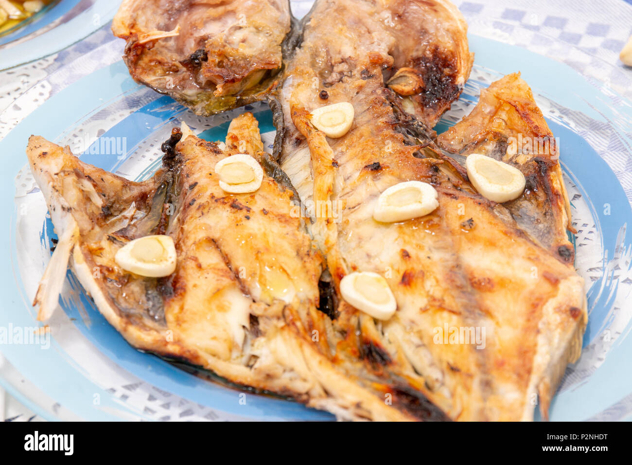 Traditional portuguese meal of grilled european seabass with potato ...