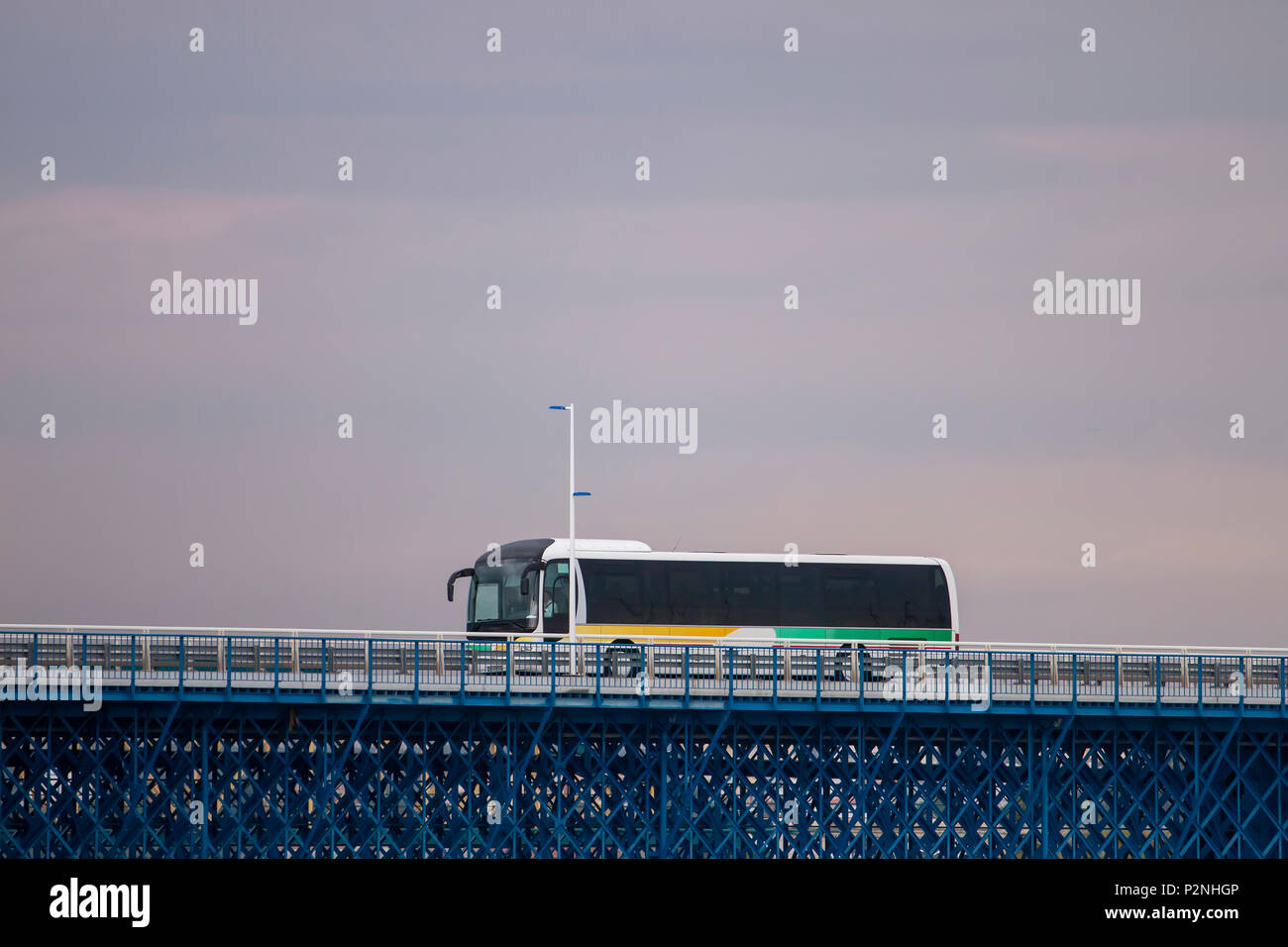 Far away view of an european bus crossing a bridge Stock Photo - Alamy