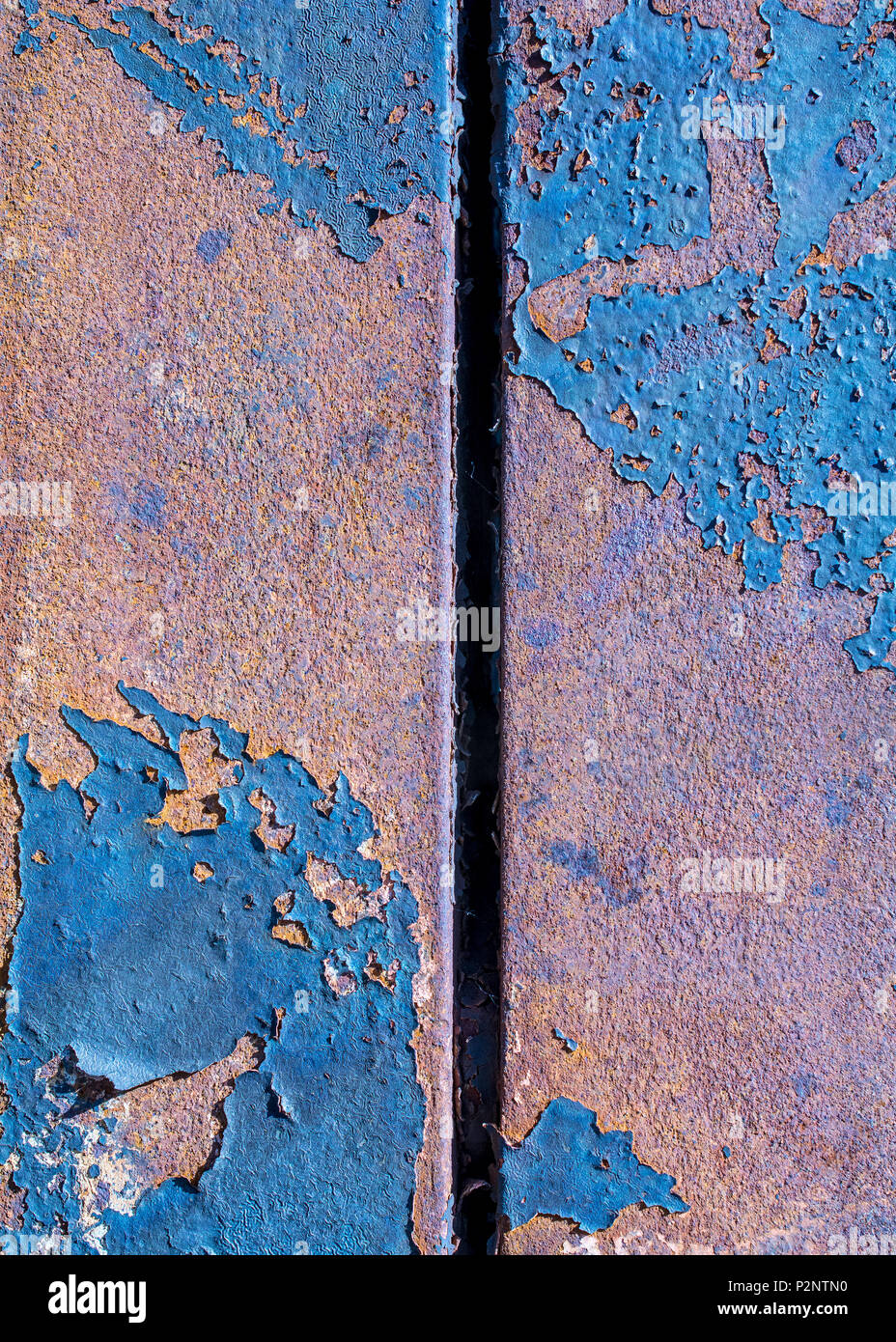 Two rusty metal pink plates with grunge, pealing off blue paint ...