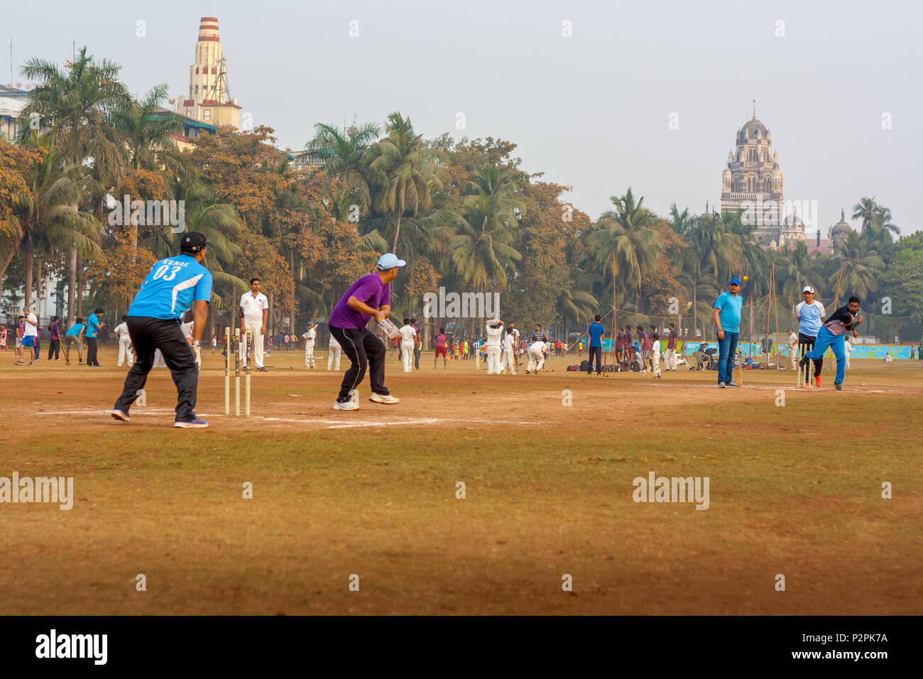 MUMBAI, INDIA - JANUARY 14, 2017 : Men playing cricket with tennis ball ...