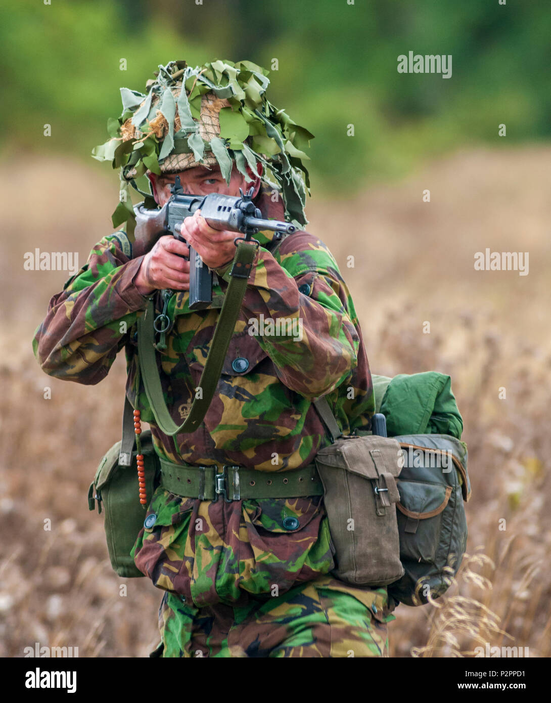 1970 – 1980 British Army soldier in camouflage suit and steel helmet ...