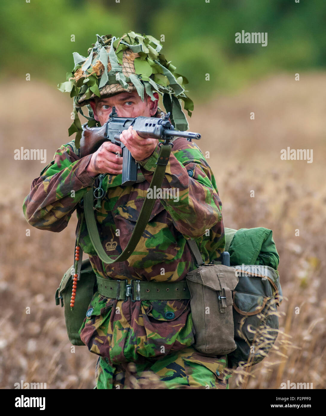 1970 – 1980 British Army soldier in camouflage suit and steel helmet ...