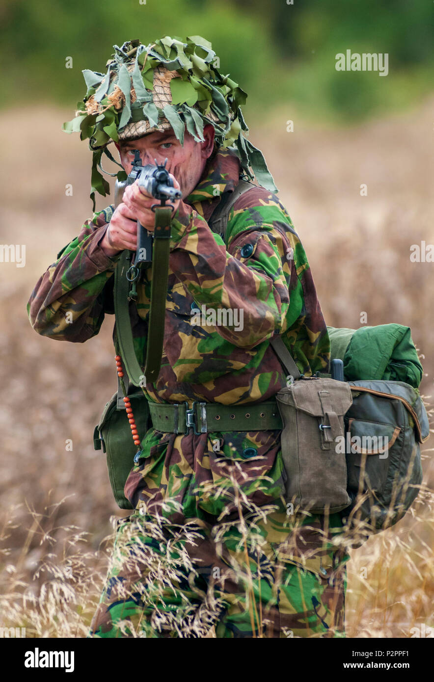 1970 – 1980 British Army soldier in camouflage suit and steel helmet ...