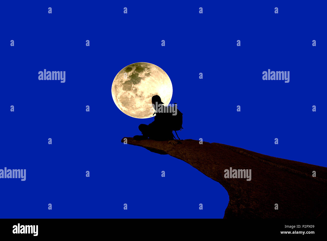 Travel photographer, standing on the edge of a cliff and gazing at the ...