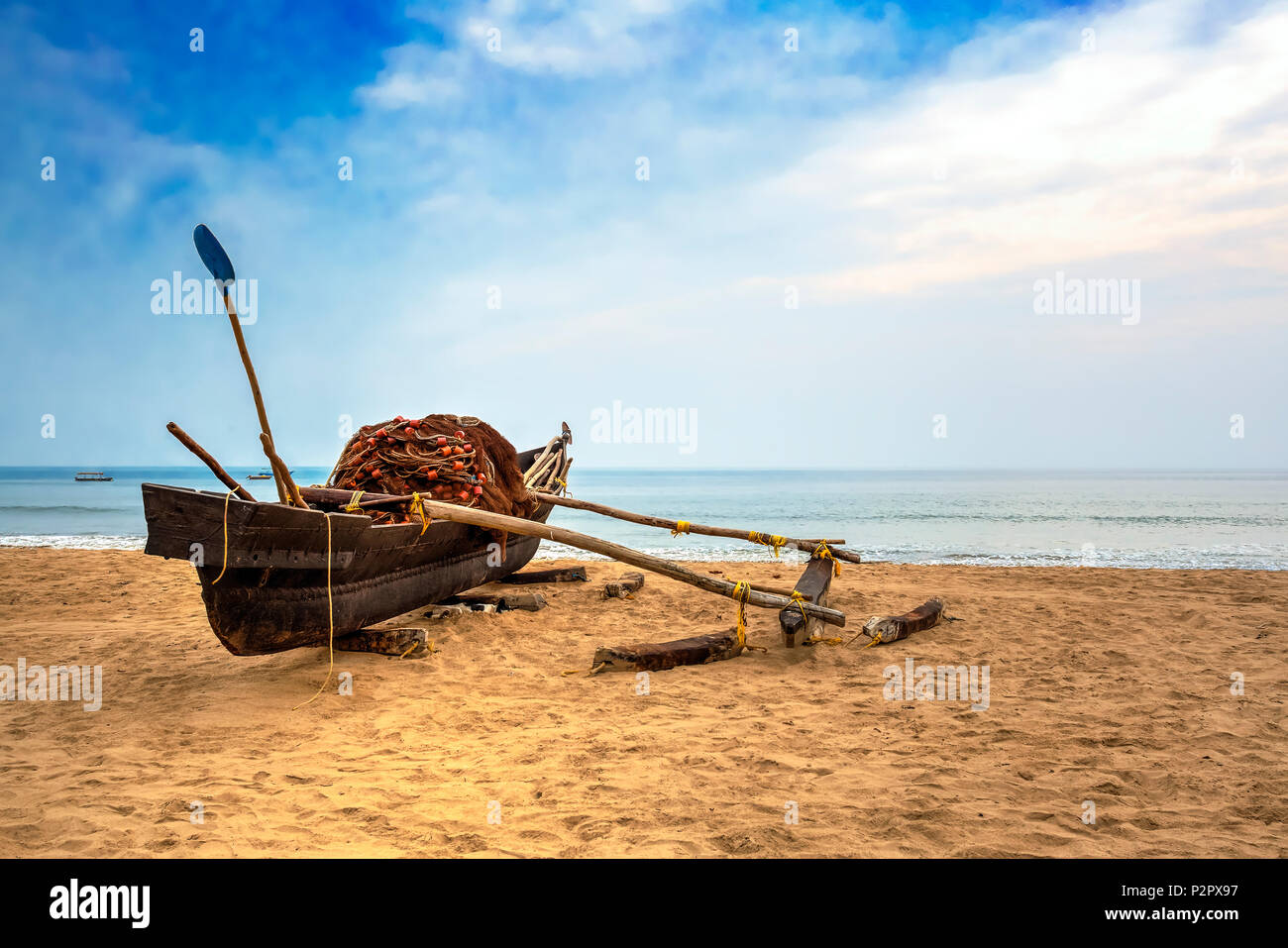 Traditional fishing boat on Goa beach, India Stock Photo - Alamy