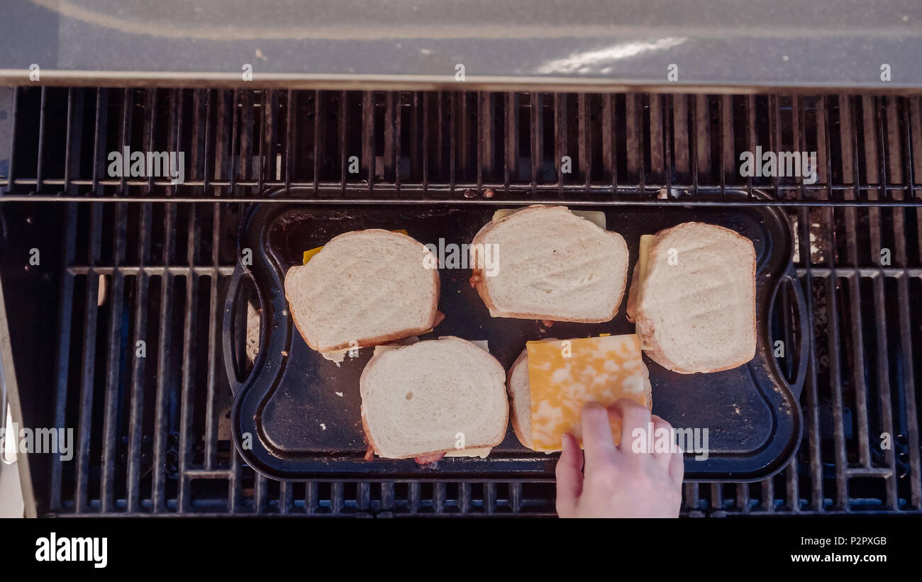 Cooking grilled cheese sandwich on outdoor gas grill Stock Photo - Alamy