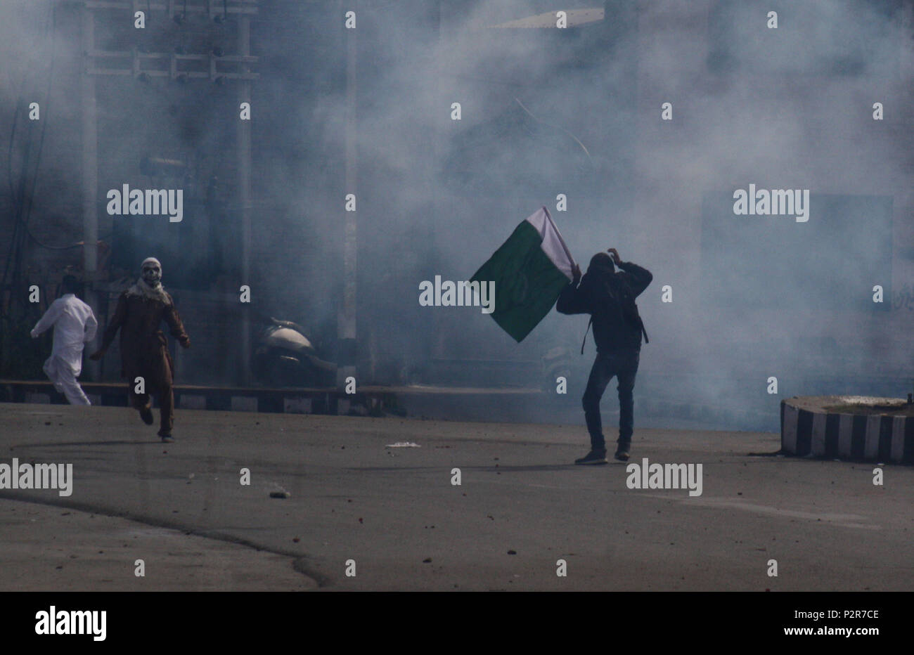 Srinagar, Kashmir. 15th Jun, 2018. Kashmiri masked protesters shout ...