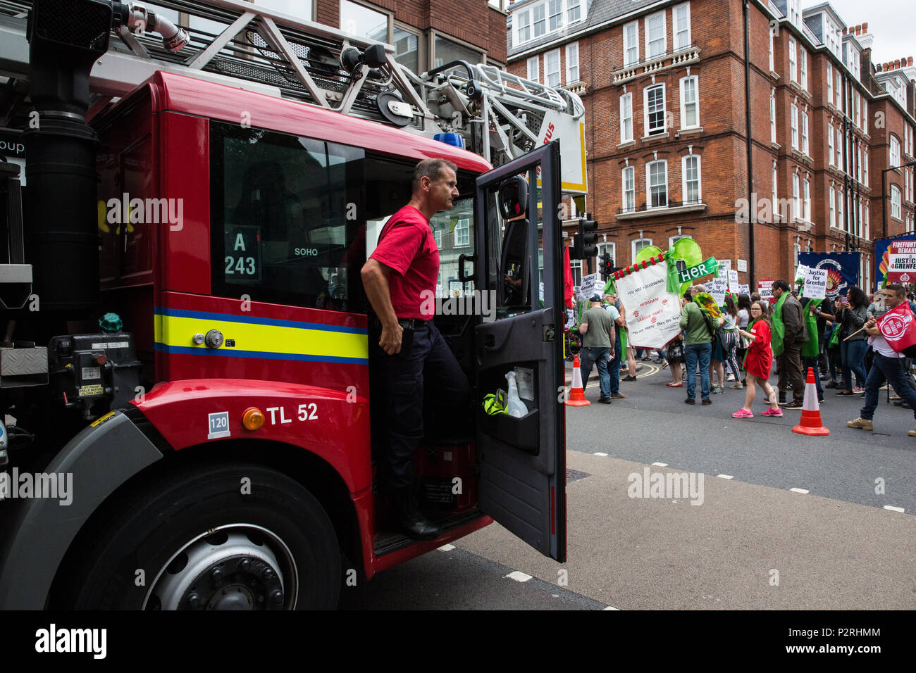 London, UK. 16th June, 2018. A firefighter stops to show solidarity ...