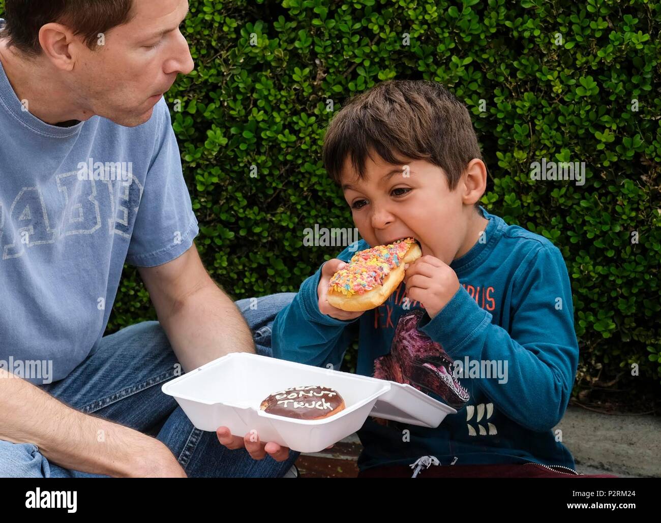 Los Angeles, USA. 16th June, 2018. A boy enjoys his donut during the ...