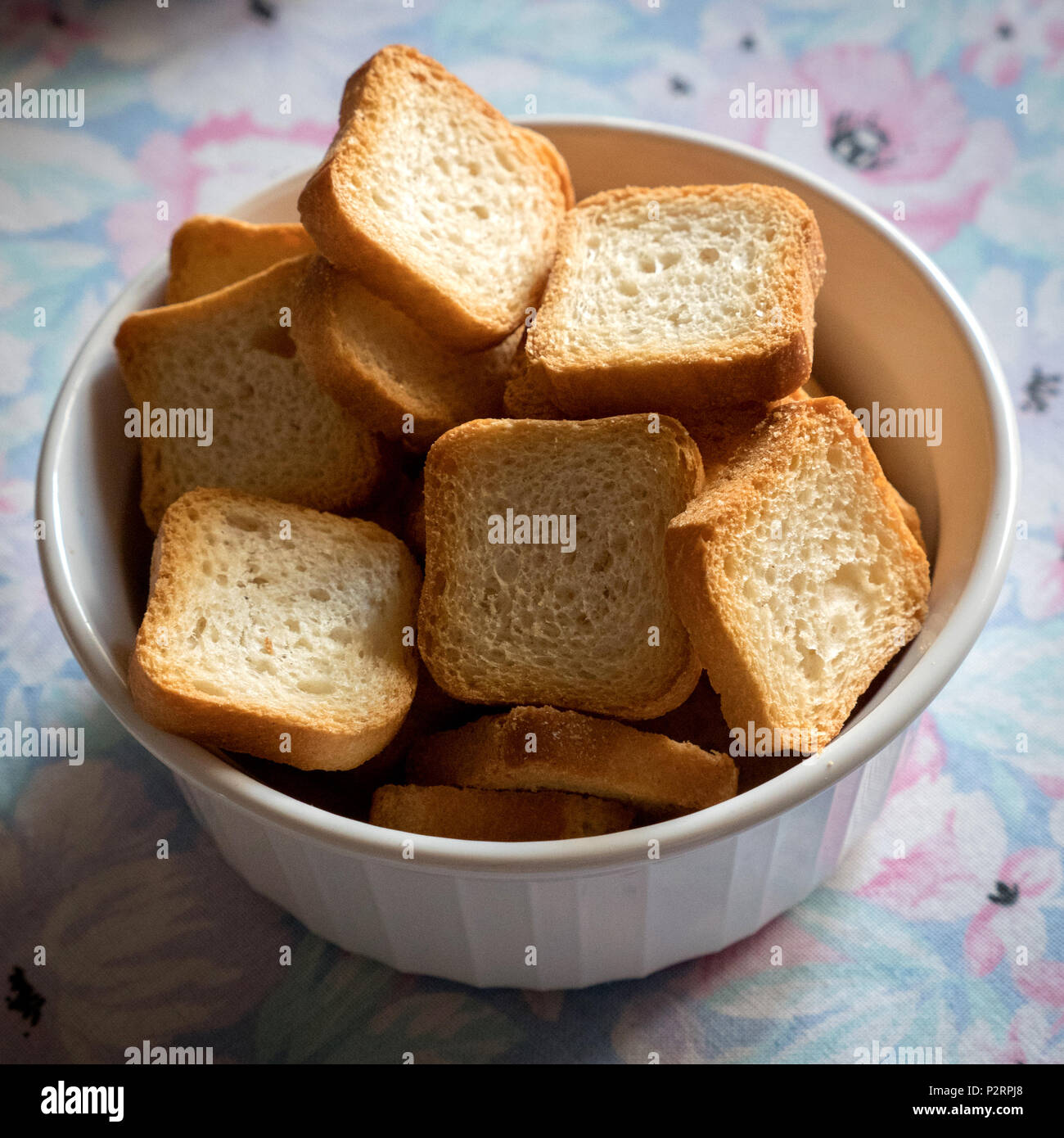 Toasted bread in small portions on white ceramic bowl Stock Photo - Alamy