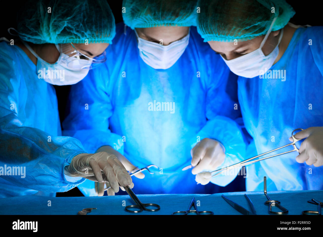 Group of surgeons in masks performing operation. Medicine, surgery and ...