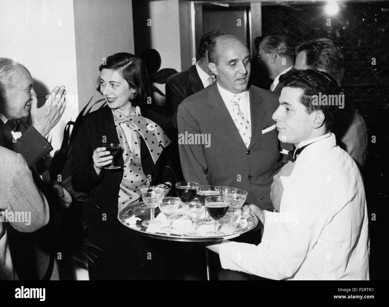. The Italian architects Cini Boeri (on the left with the wine glass in ...