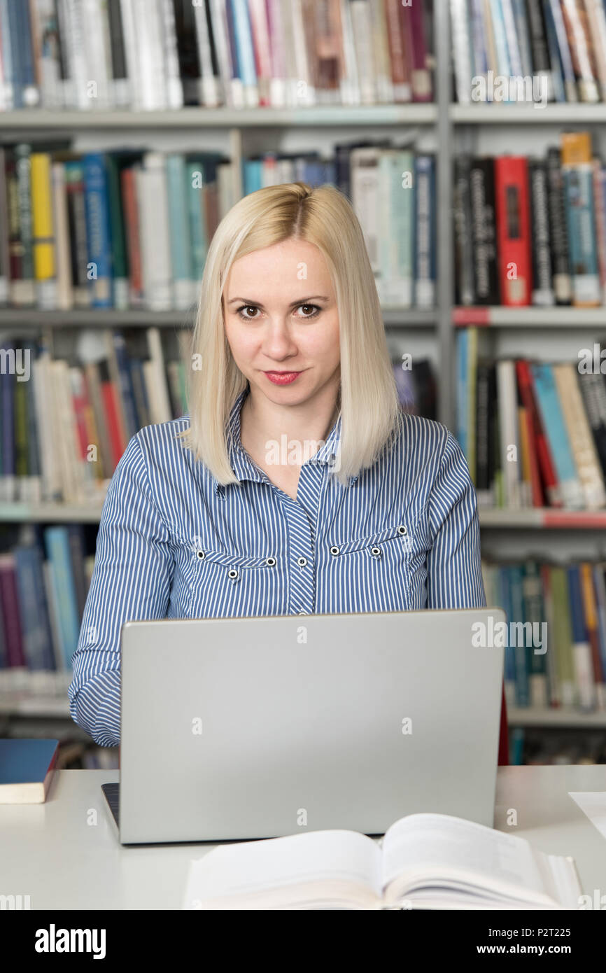Portrait of an Attractive Student Doing Some School Work With a Laptop ...
