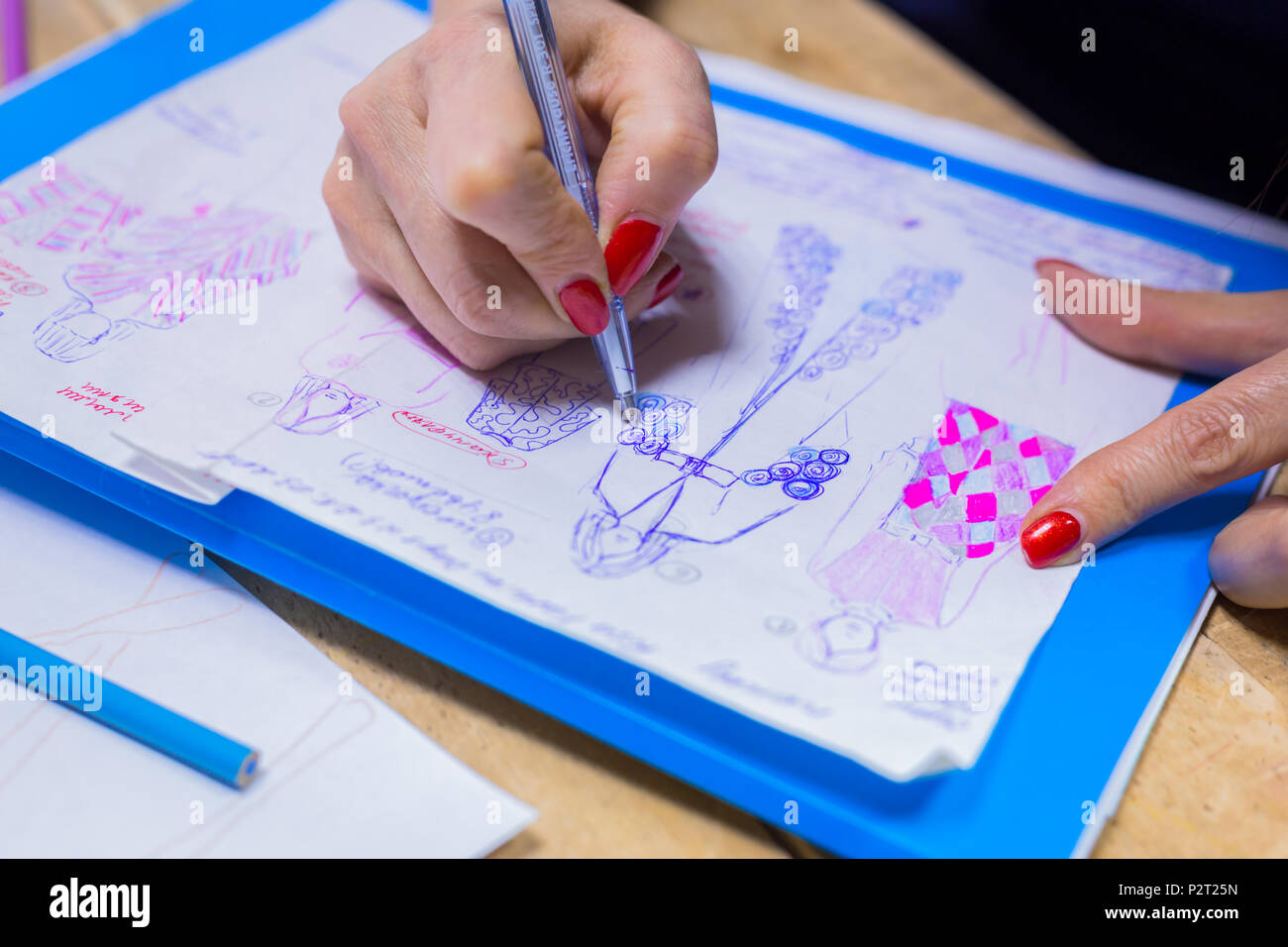 Close up shot - hands of professional tailor, designer drawing fashion ...