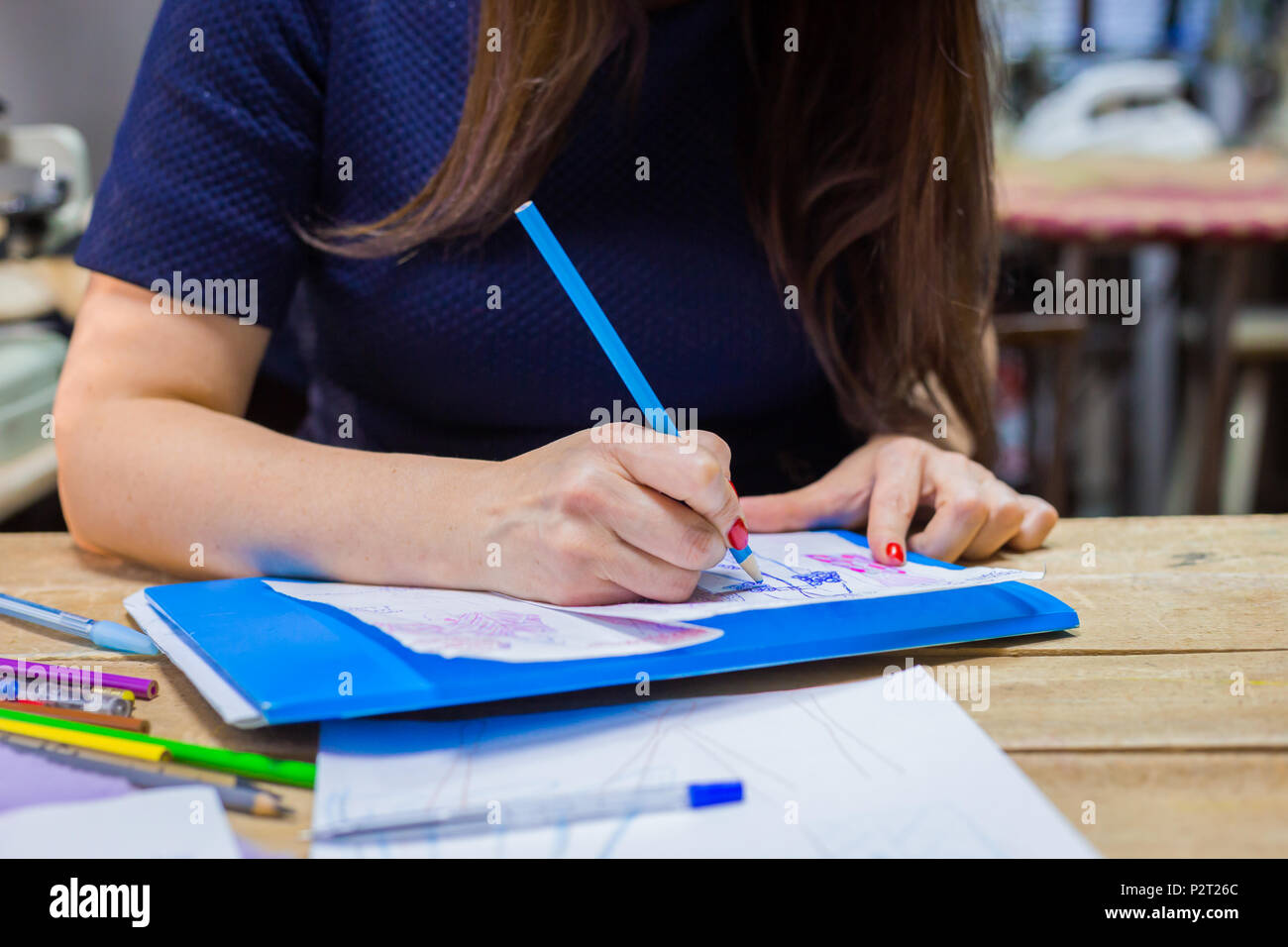 Close up shot - hands of professional tailor, designer drawing fashion ...