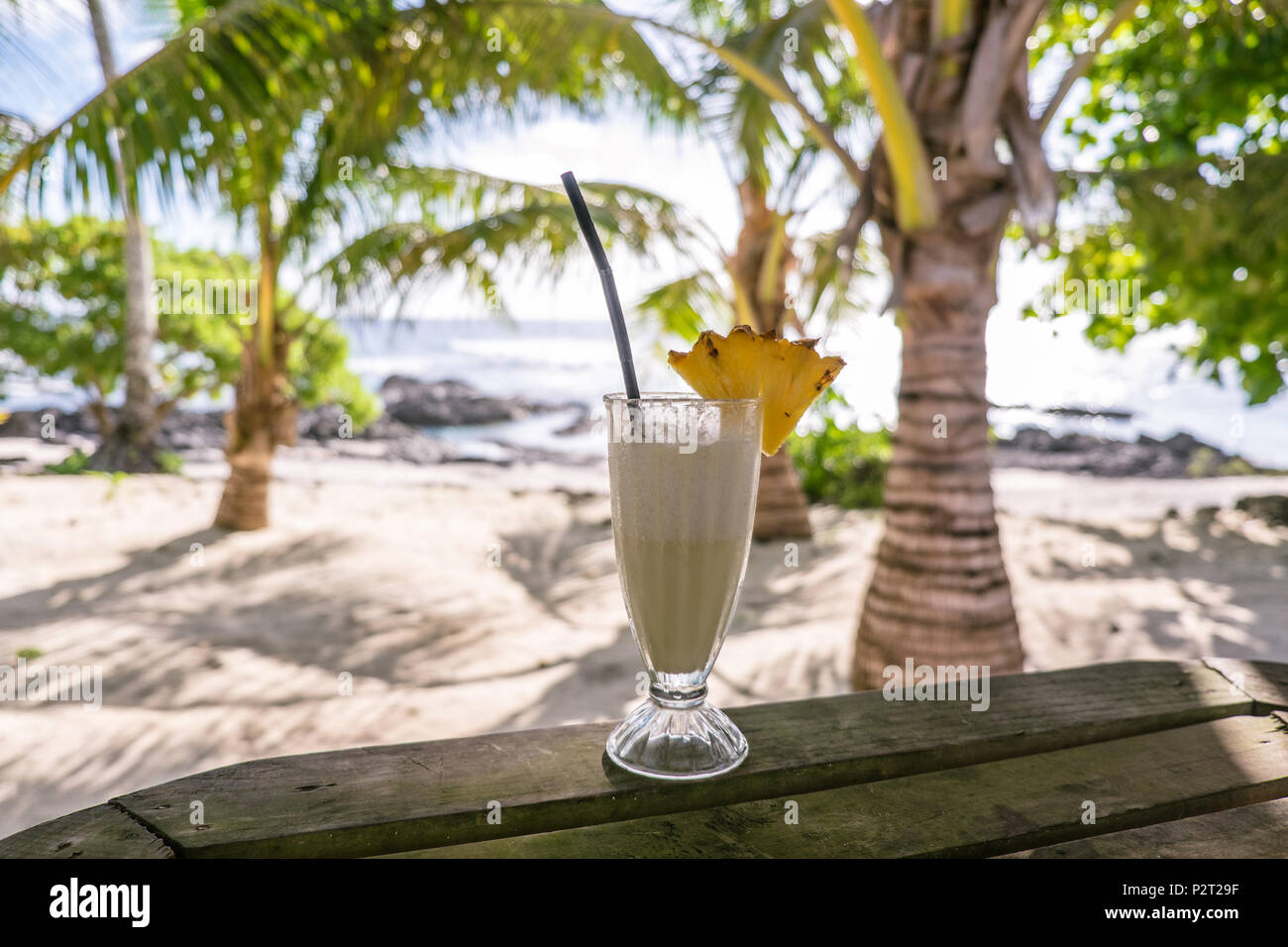 Tropical pina colada cocktail drink with pineapple garnish in glass ...