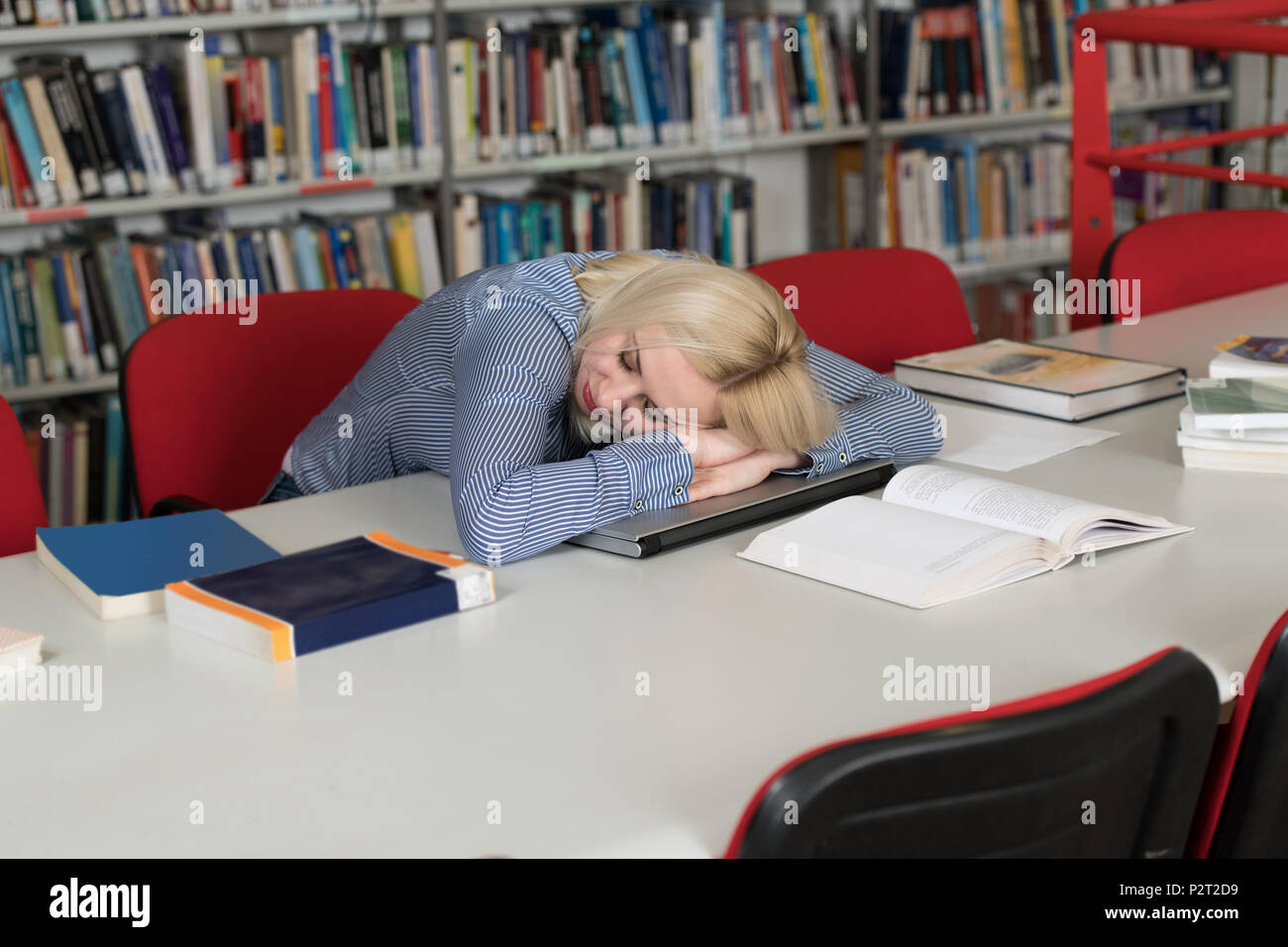In the Library Pretty Female Student With Books Sleeping in a High ...