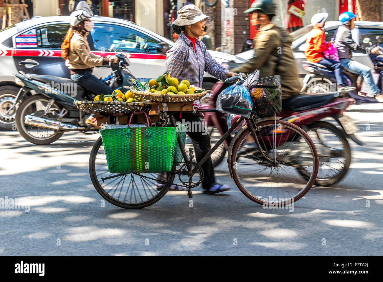 Vendors one foot,motorcyce and cycle in Hanoi Vietnam Stock Photo - Alamy