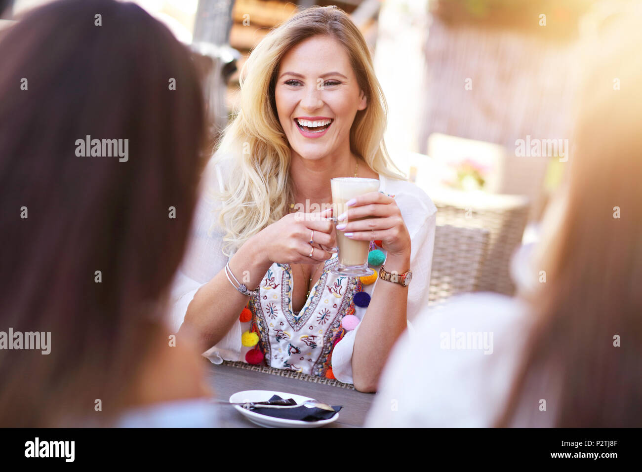 Happy girl friends in cafe during summer time Stock Photo - Alamy