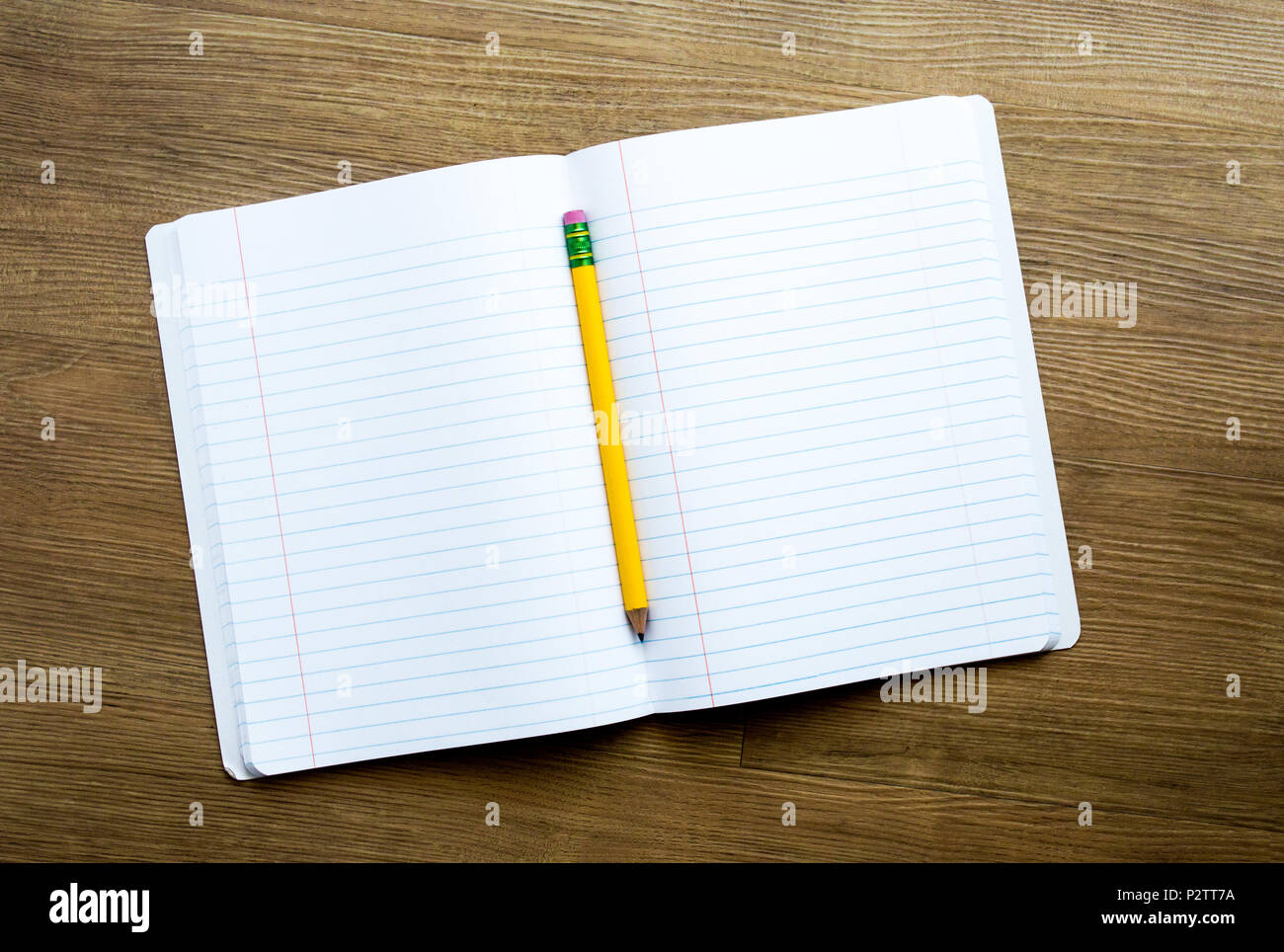 yellow pencil on top of a notebook with blank pages for customized ...