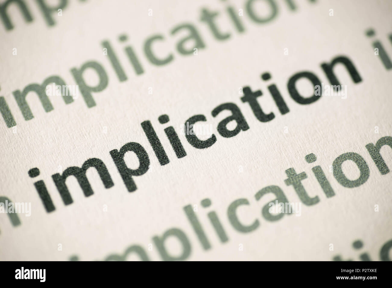 word implication printed on white paper macro Stock Photo - Alamy