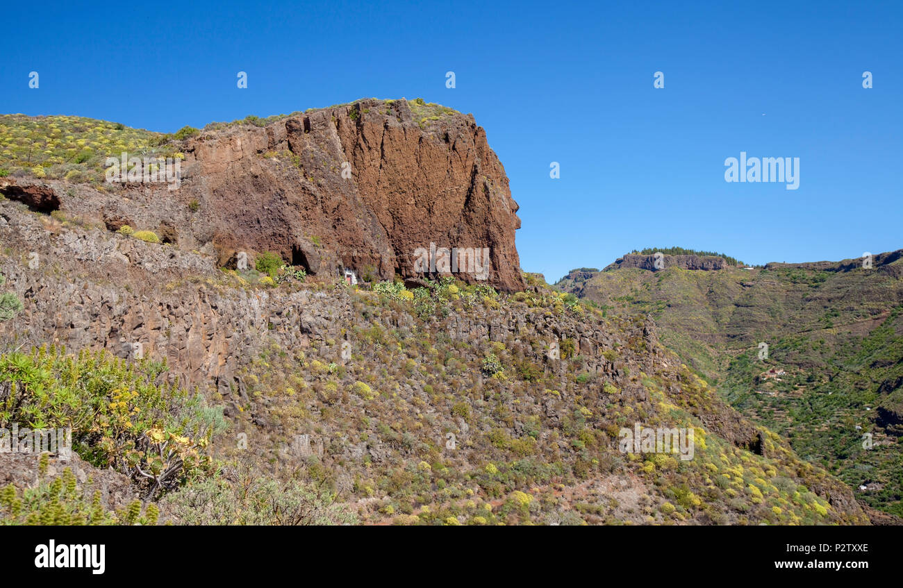 Gran Canaria, June, steep walls of ravine Barranco de Guayadeque, caves ...