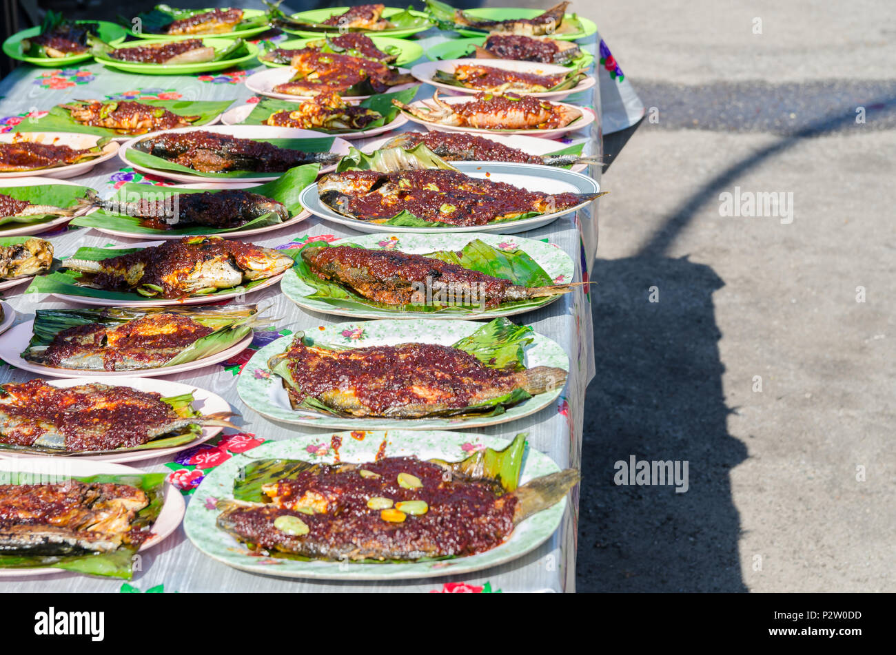 Grilled fish with spicy sauce on plate selling in Ramadan Bazaar Kuala ...