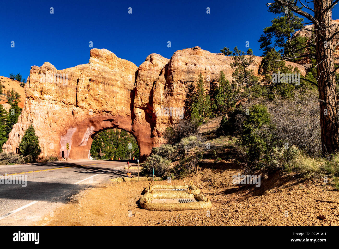 Arch in the road near Bryce National Park Stock Photo - Alamy