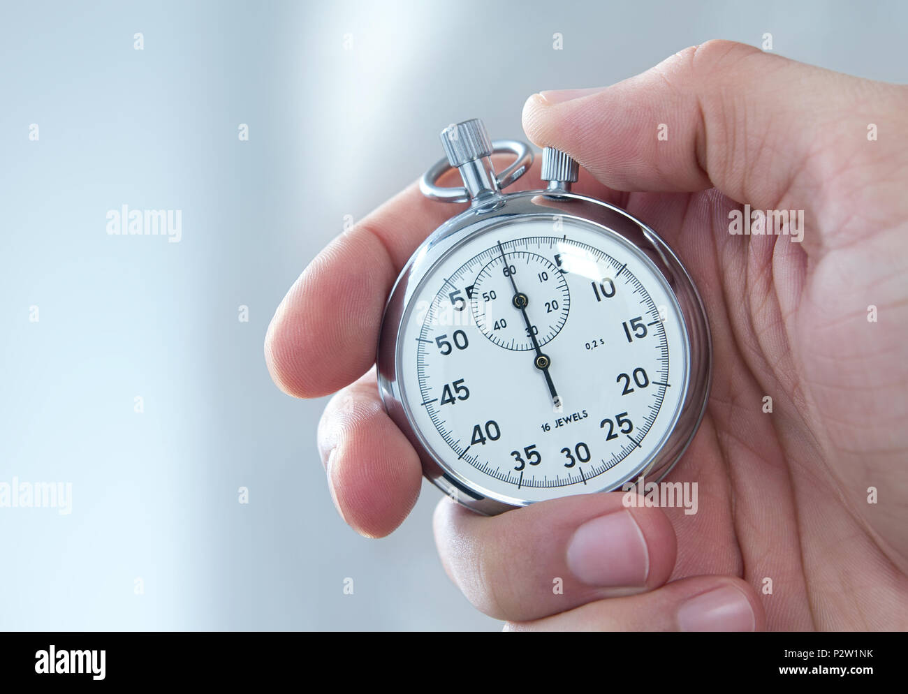 Hand and stopwatch hi-res stock photography and images - Alamy