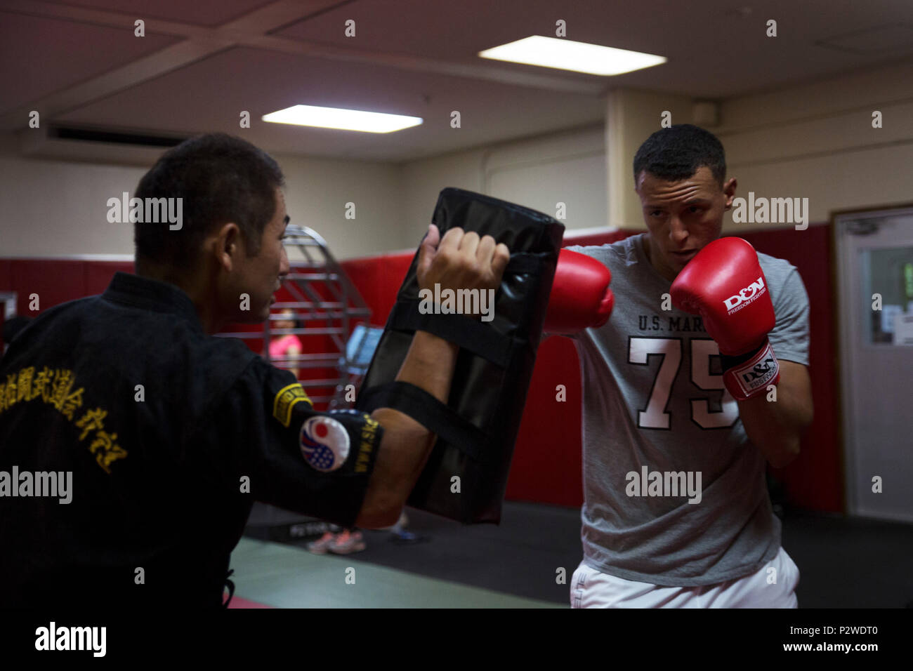 Nobuhiro Hirahara, left, calls out boxing commands while instructing ...