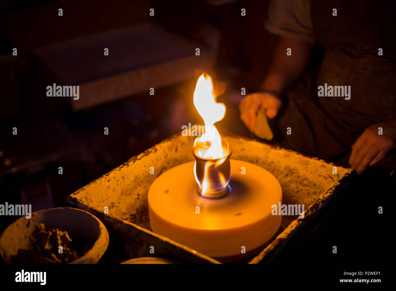 Burning ceramic mug on pottery wheel in workshop, studio. Handmade, art ...