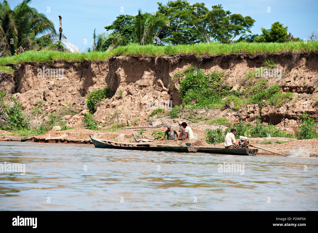 Working villagers travel along the amazon river in long boats and ...