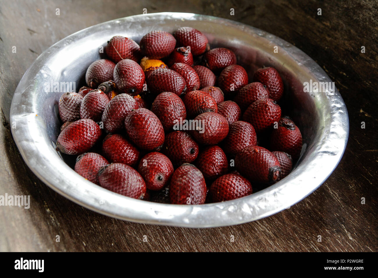 Close up of fresh "buriti" fruit inside metal bowl in Amazon rainforest ...