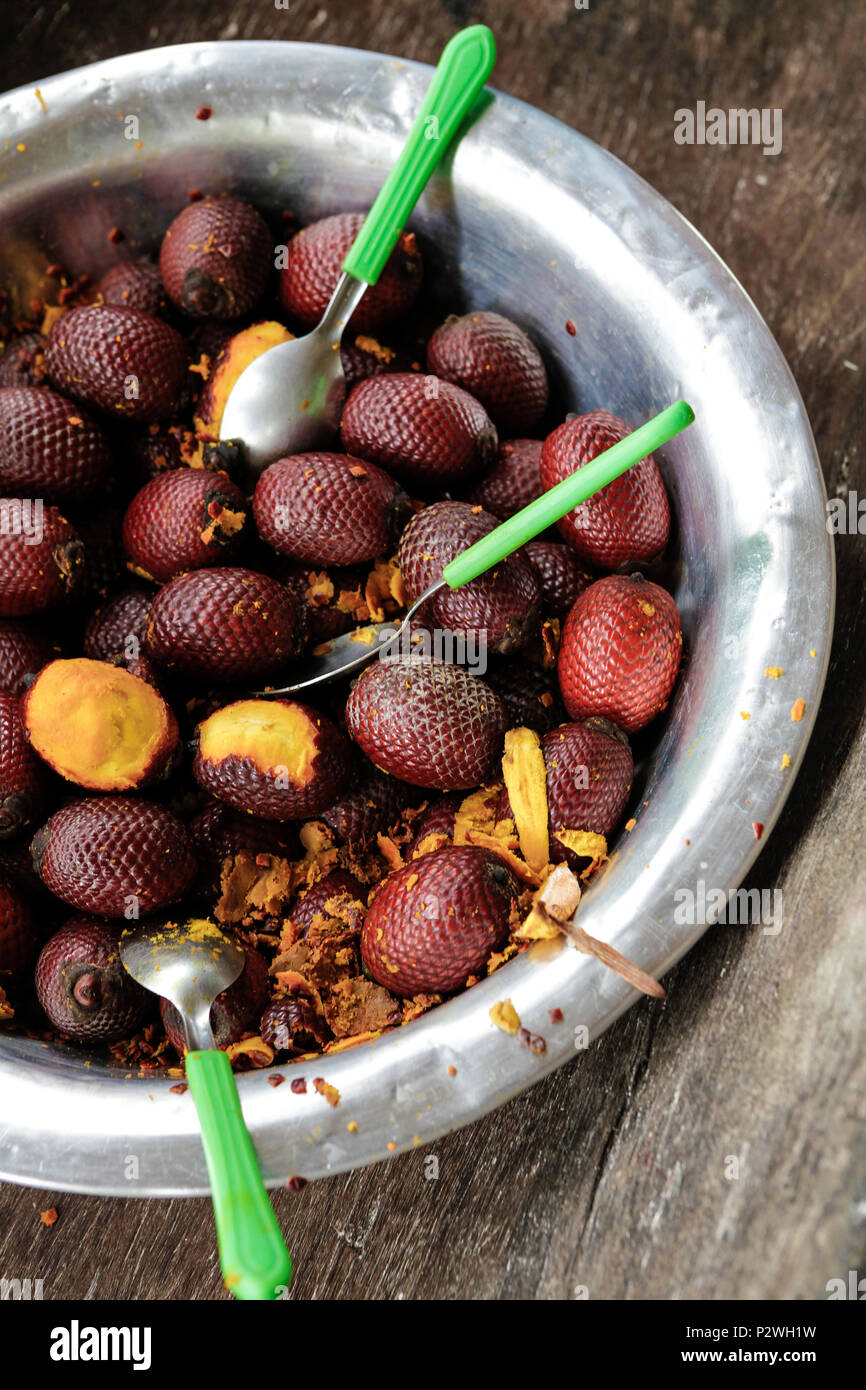 Close up of fresh "buriti" fruit with spoons inside a metal bowl in ...