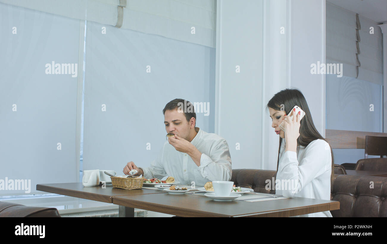Couple busy with phone dinner table hi-res stock photography and images ...