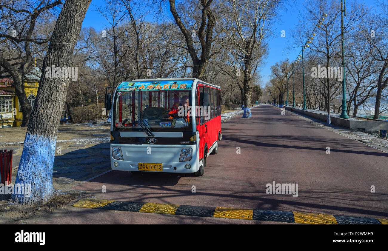 Harbin, China - Feb 22, 2018. Tourist bus waiting at tree park in ...