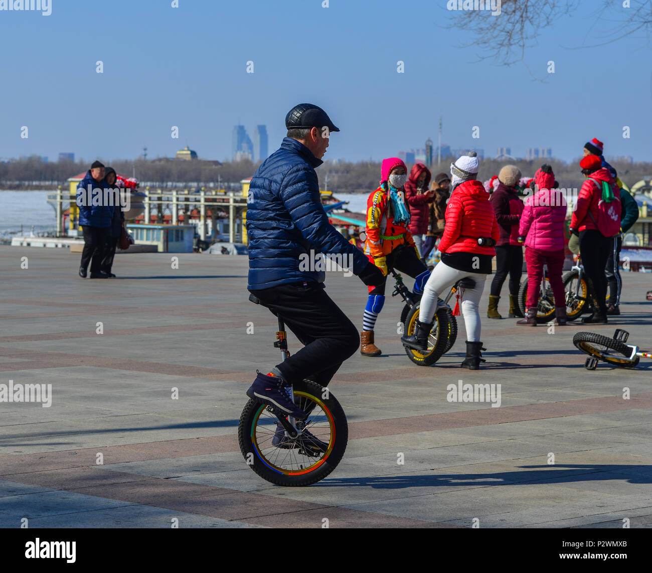 Harbin, China - Feb 22, 2018. People playing one-wheel bicycle at the ...