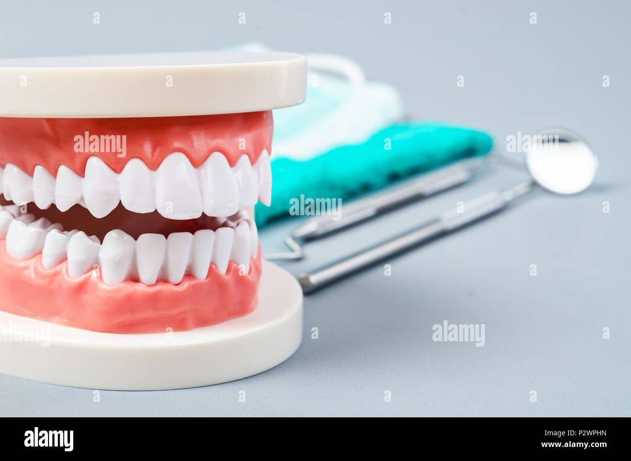 White teeth and dental instruments on table background. Dentist concept ...