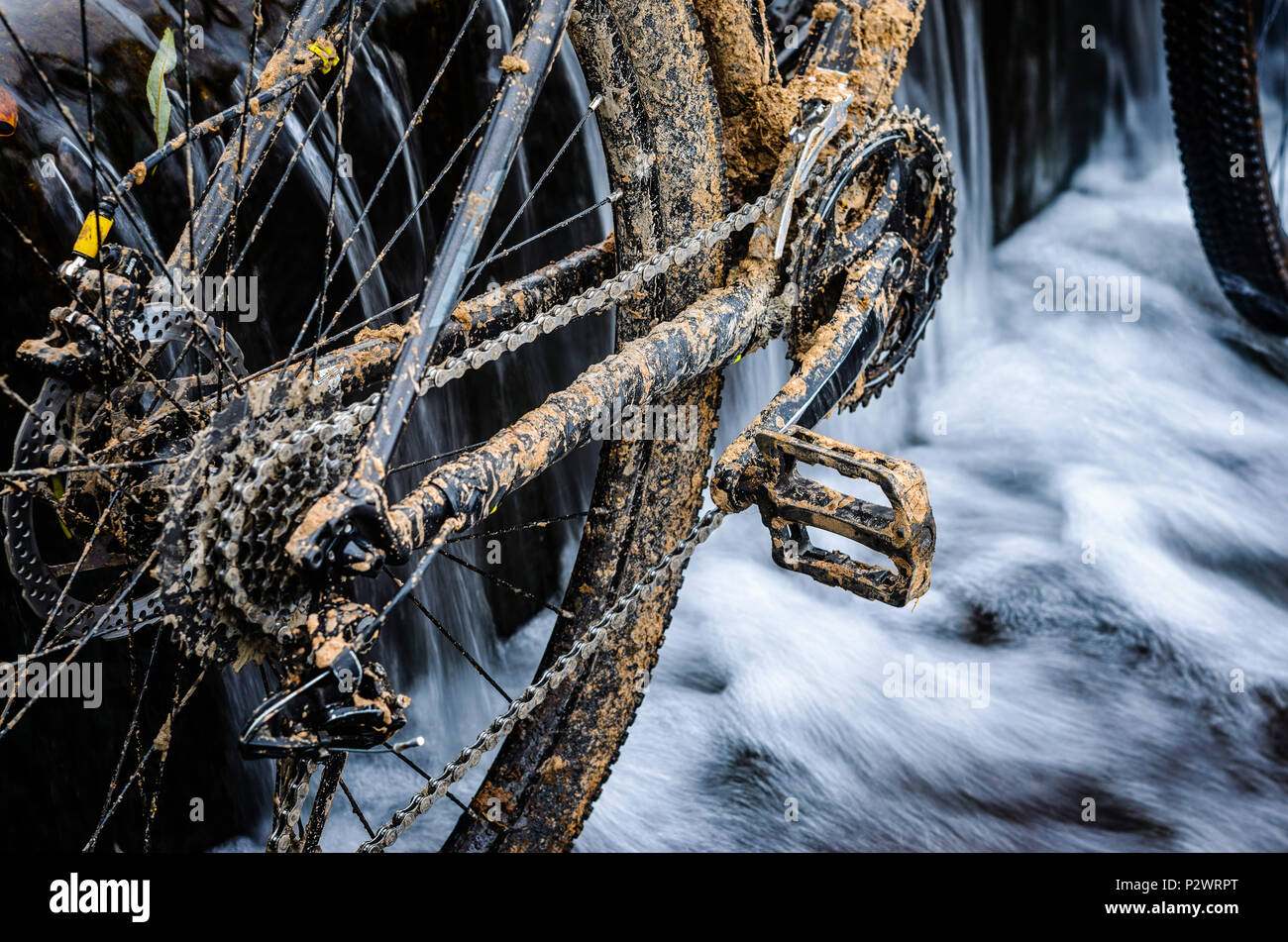 Dirty Mountain Bike Stands in a Creek Against the Small Waterfall ...