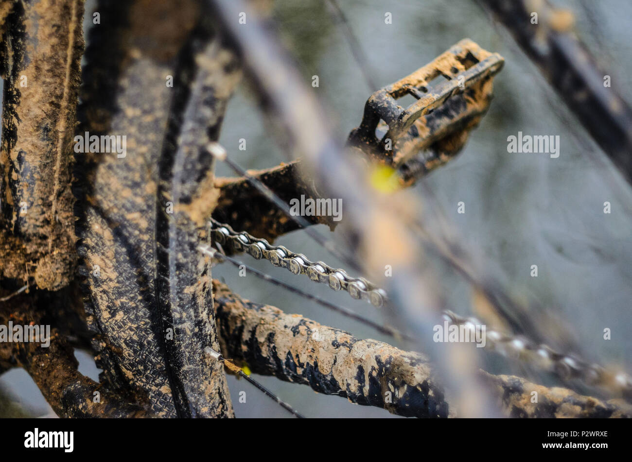 A bicycle in the mud. Elements of a mountain bike frame covered with ...
