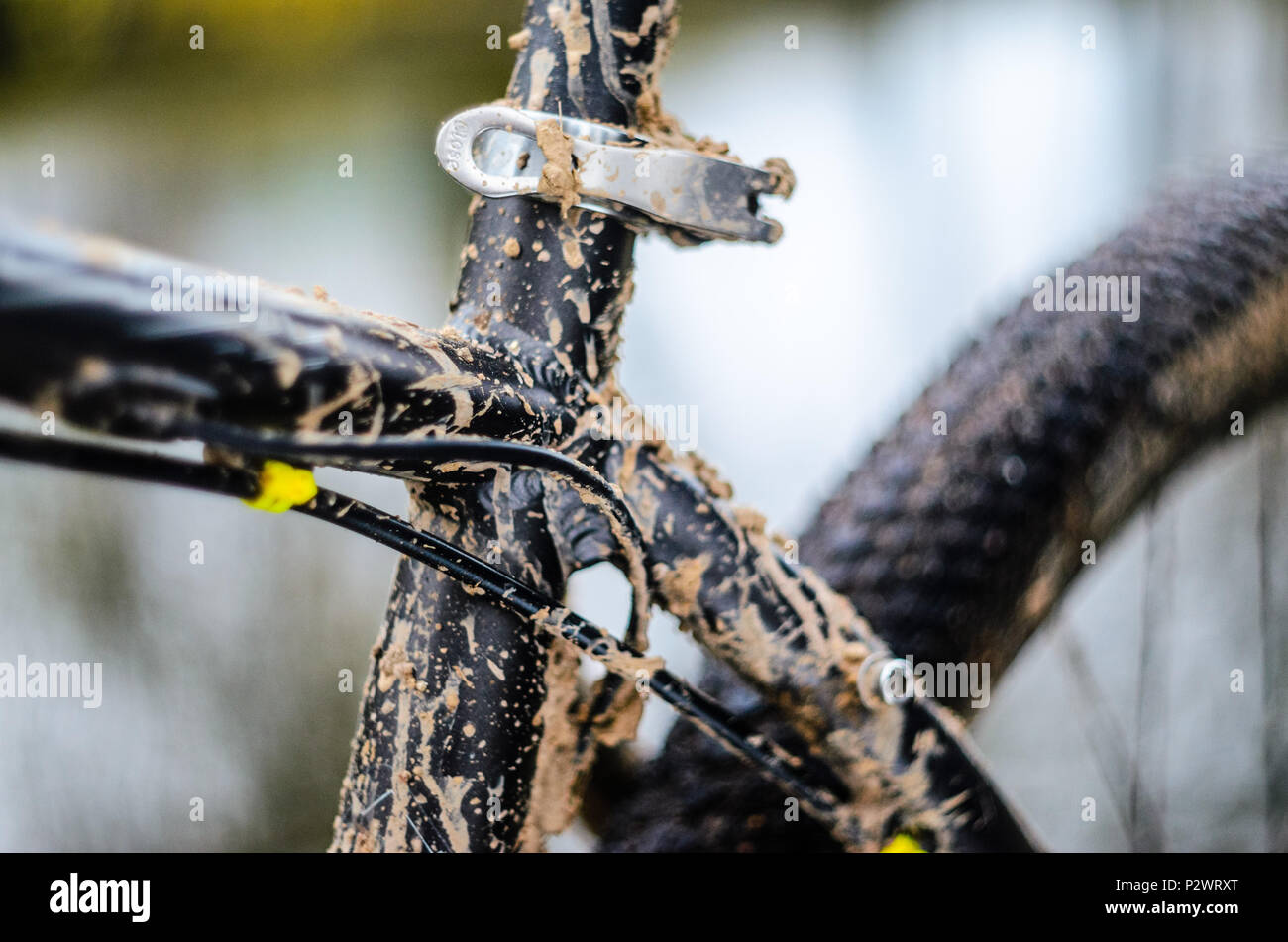 A bicycle in the mud. Elements of a mountain bike frame covered with ...