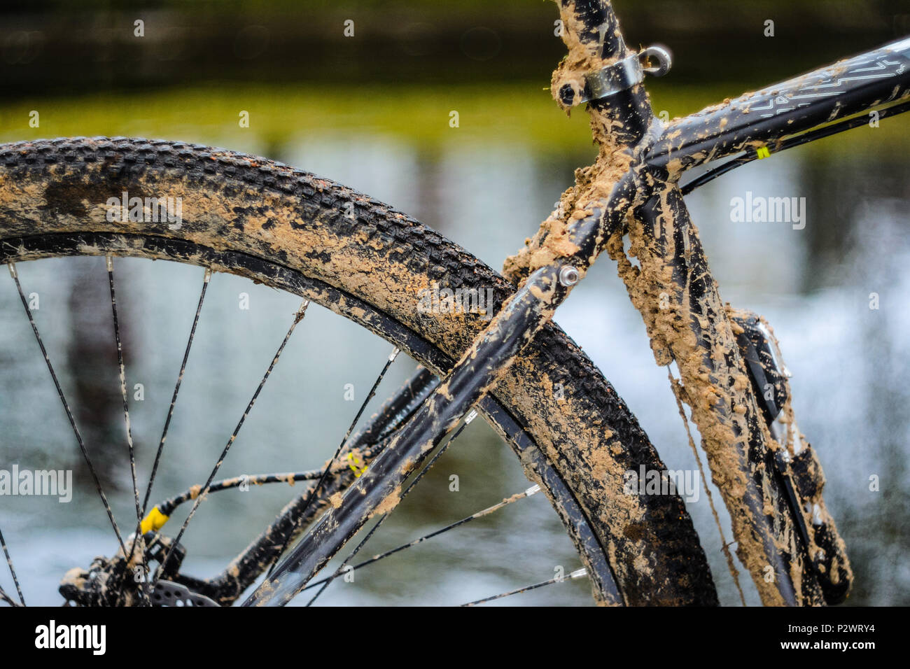 A bicycle in the mud. Elements of a mountain bike frame covered with ...