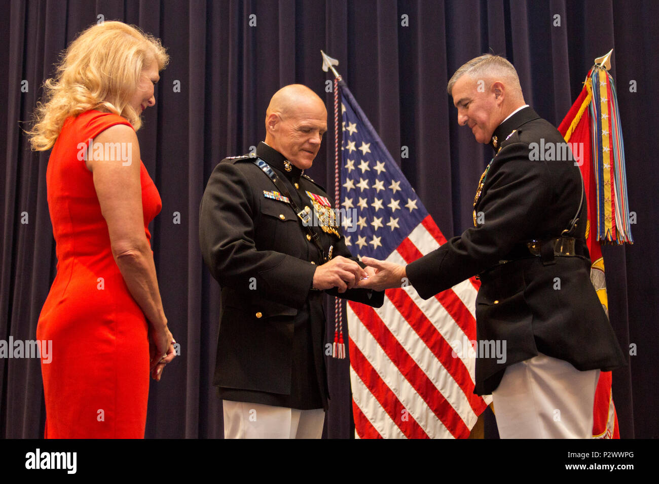 Commandant of the Marine Corps Gen. Robert B. Neller, center, holds ...