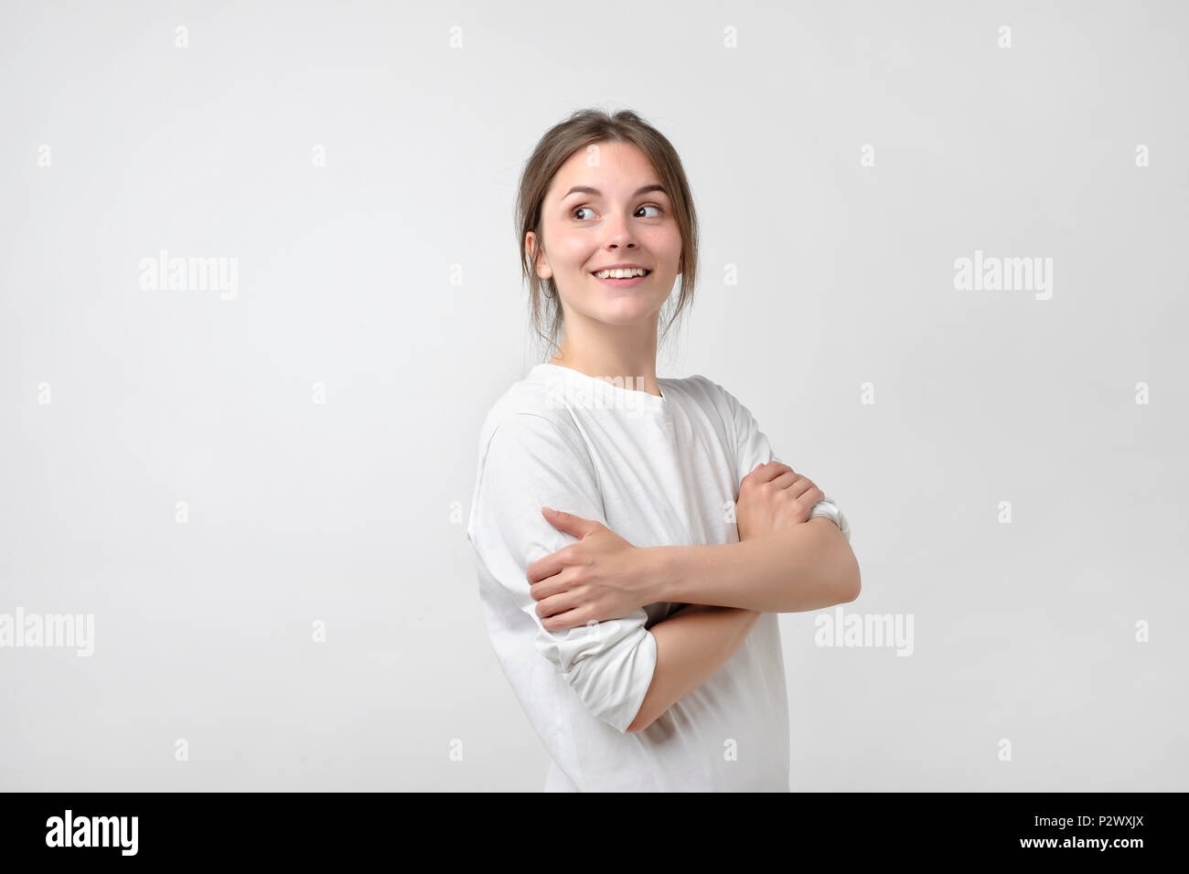 Young european woman laughing and smiling. She is a little bit shy and ...