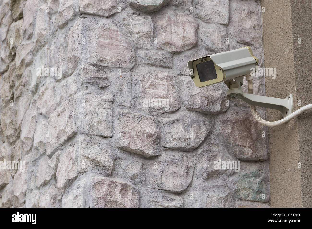 The CCTV Security Camera operating on stone brick wall background Stock ...
