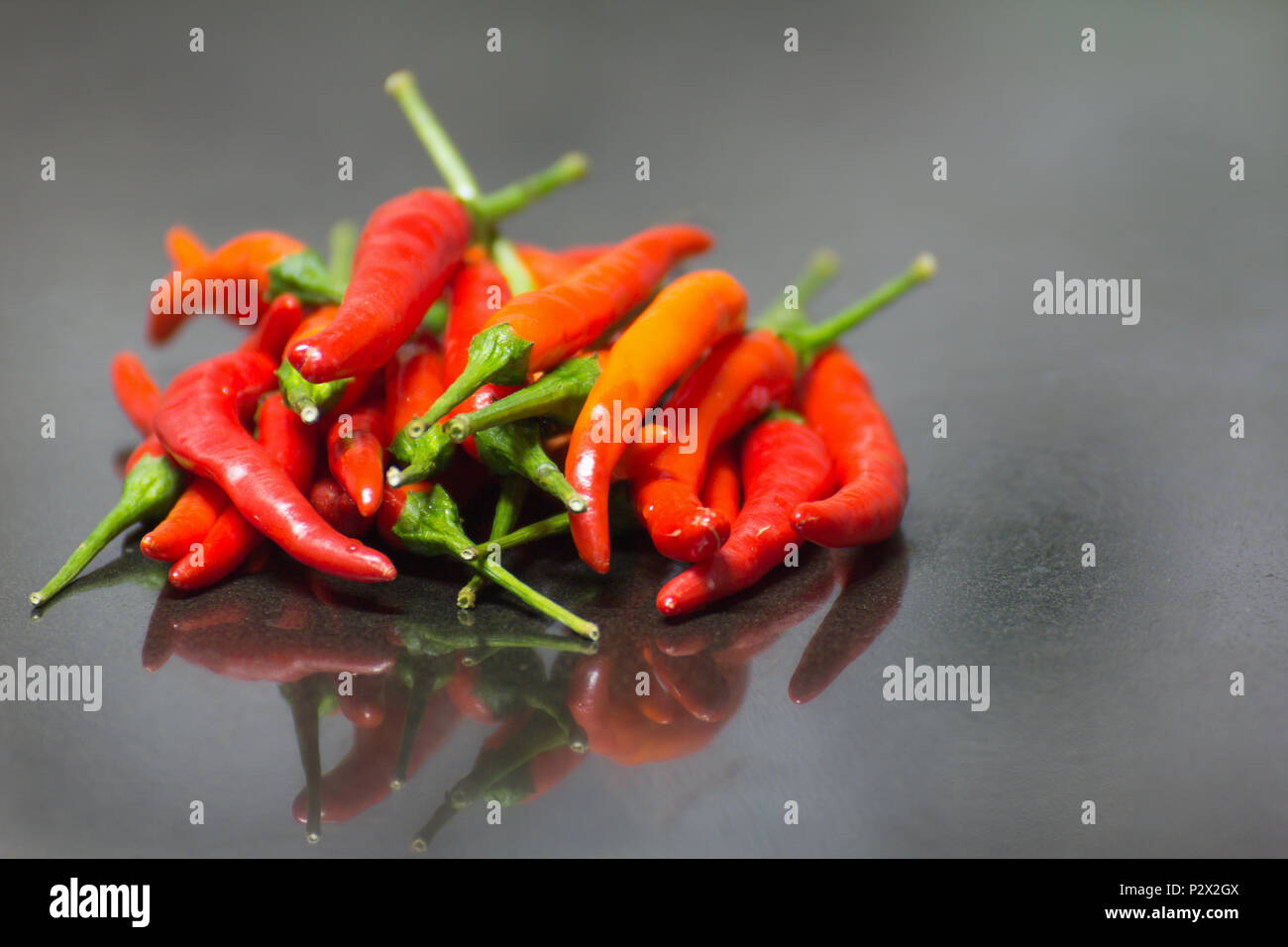 Fresh red chilli on black granite table background Stock Photo - Alamy