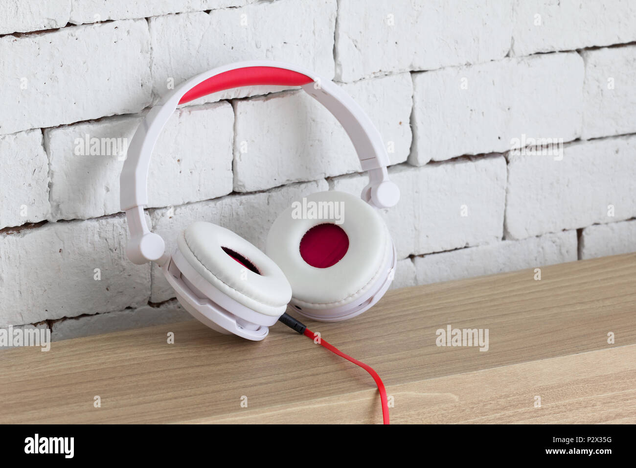 A big white and red headphones with modern background Stock Photo - Alamy